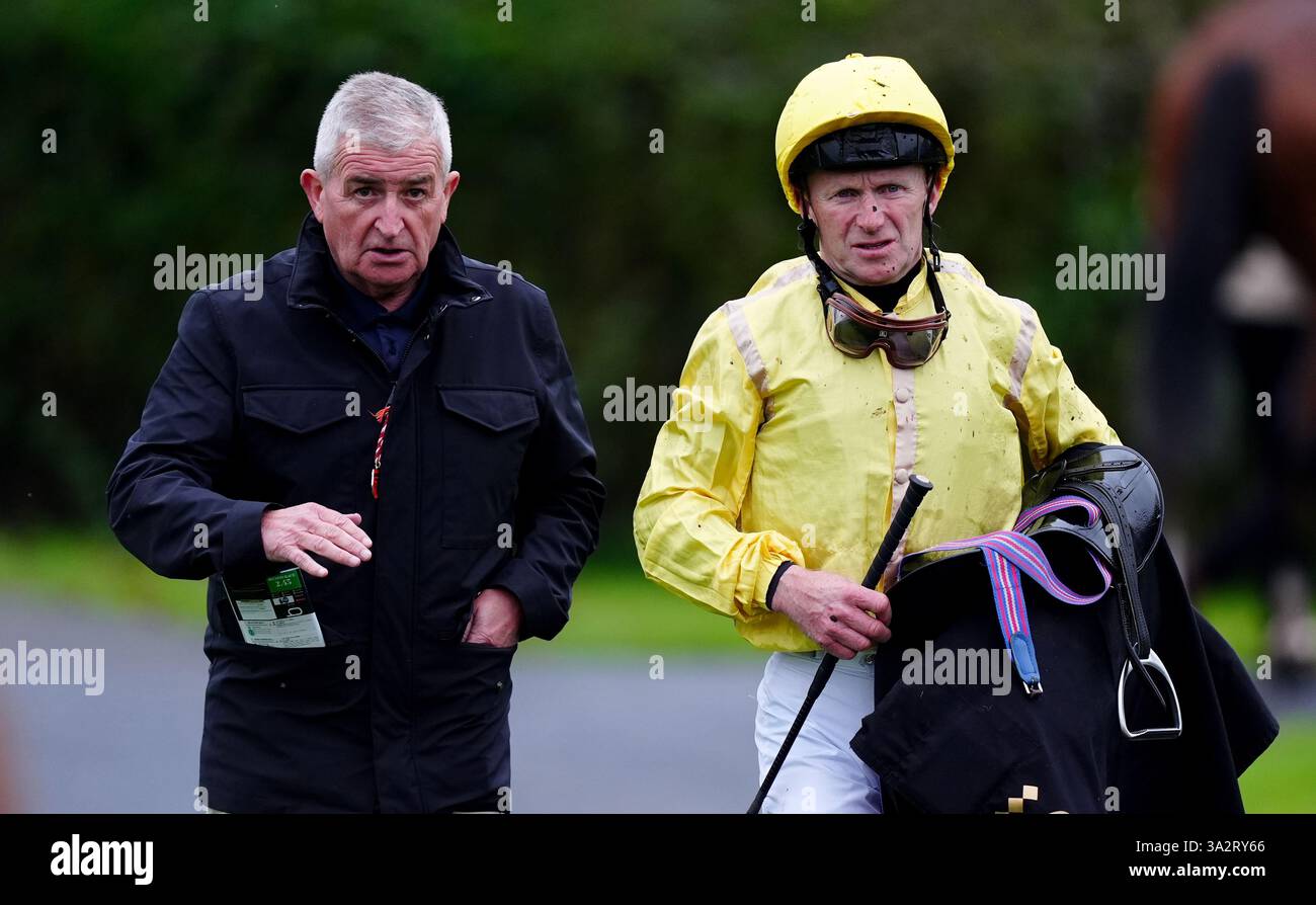 Joe Fanning (right) and his trainer Charlie Johnston (left)after the ...