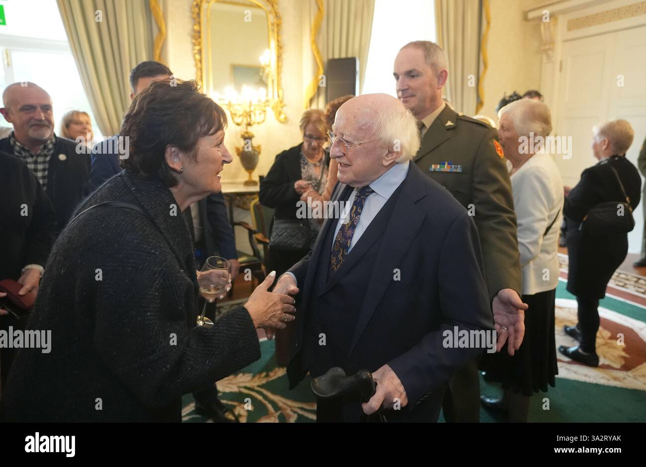 President of Ireland Michael D Higgins greets Susan Behan, whose 21 ...