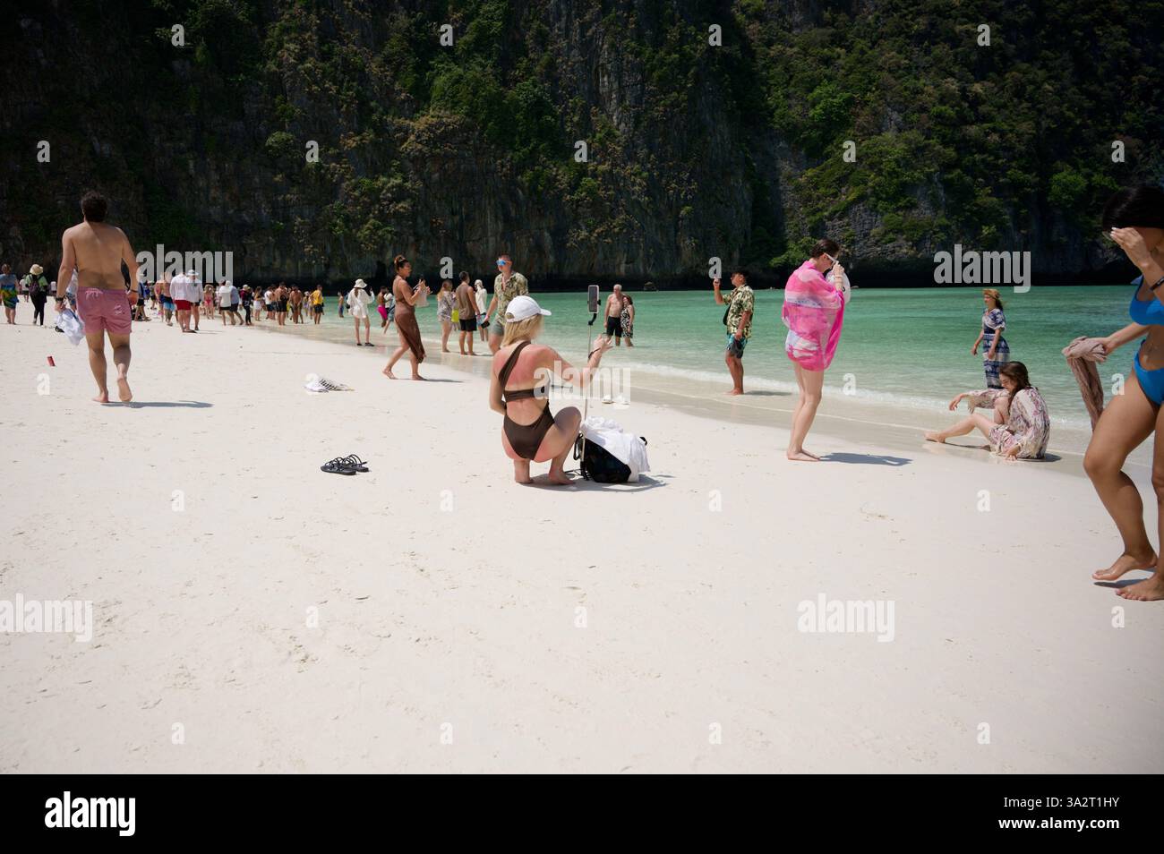 A crowded beach in Ko Phi Phi Lee, where an influencer sets to record a ...