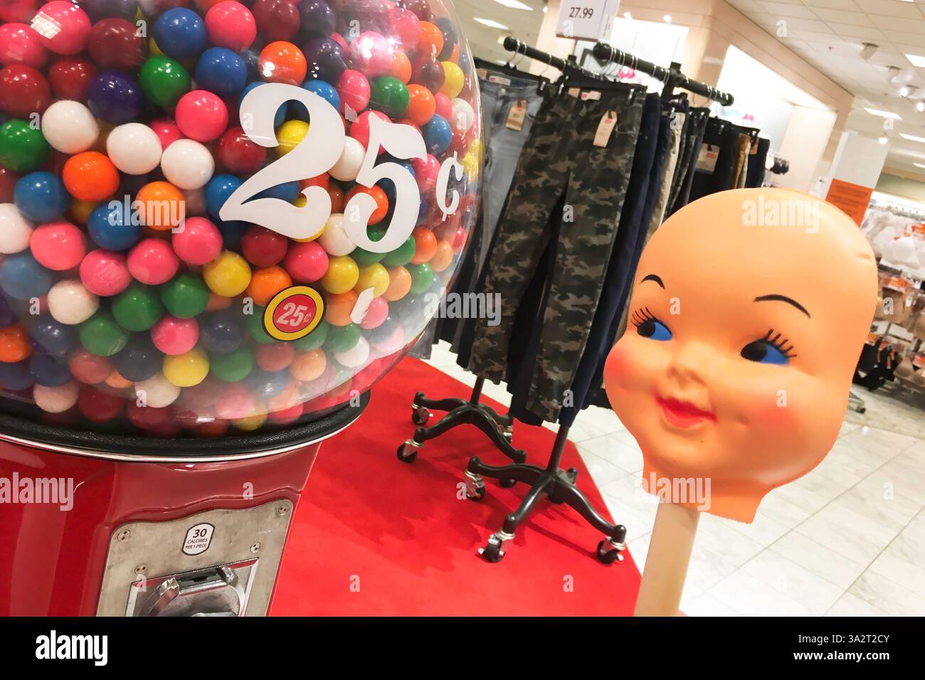 smiley face toy with gumball machine Stock Photo - Alamy