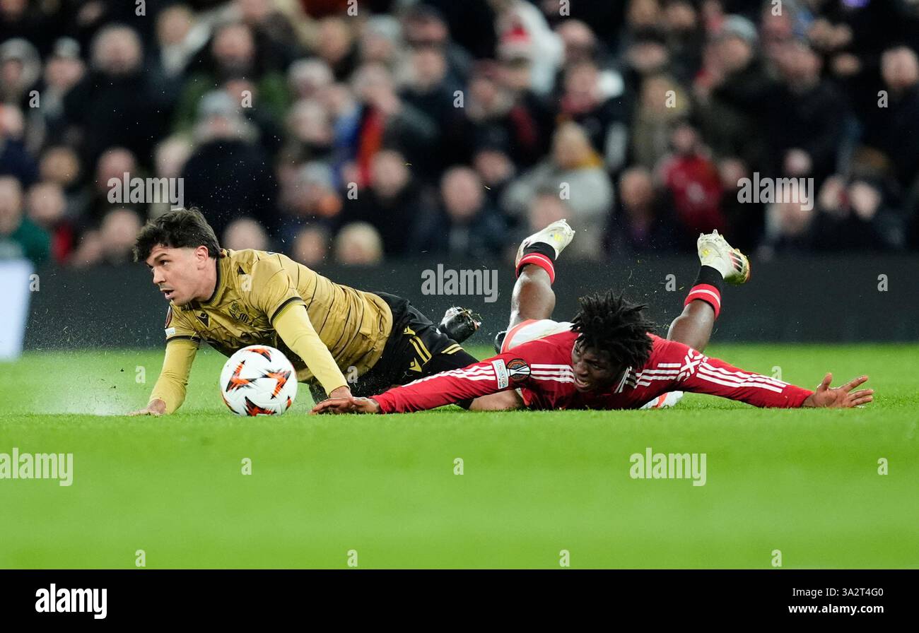 Manchester United's Patrick Dorgu (right) is fouled by Real Sociedad's ...