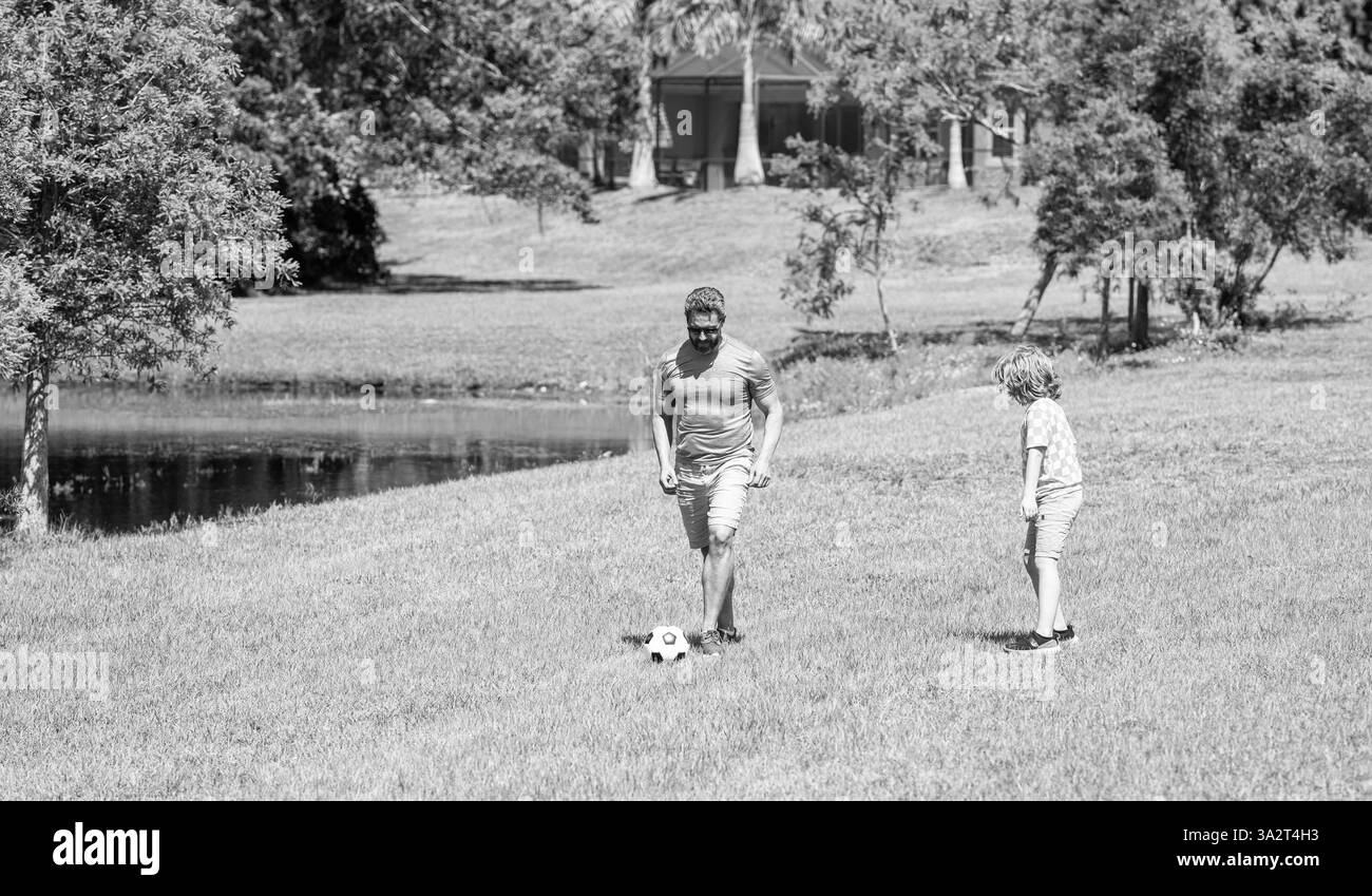 Father dad and son enjoying outdoor activities together. kicking soccer ...