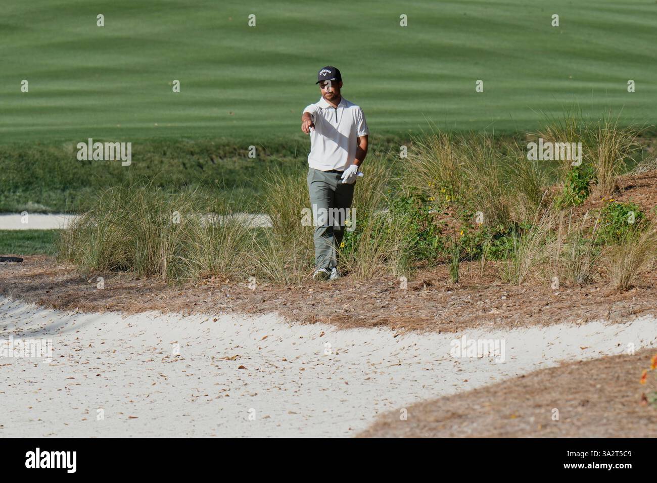 Xander Schauffele looks for his ball on the 14th hole during the first ...