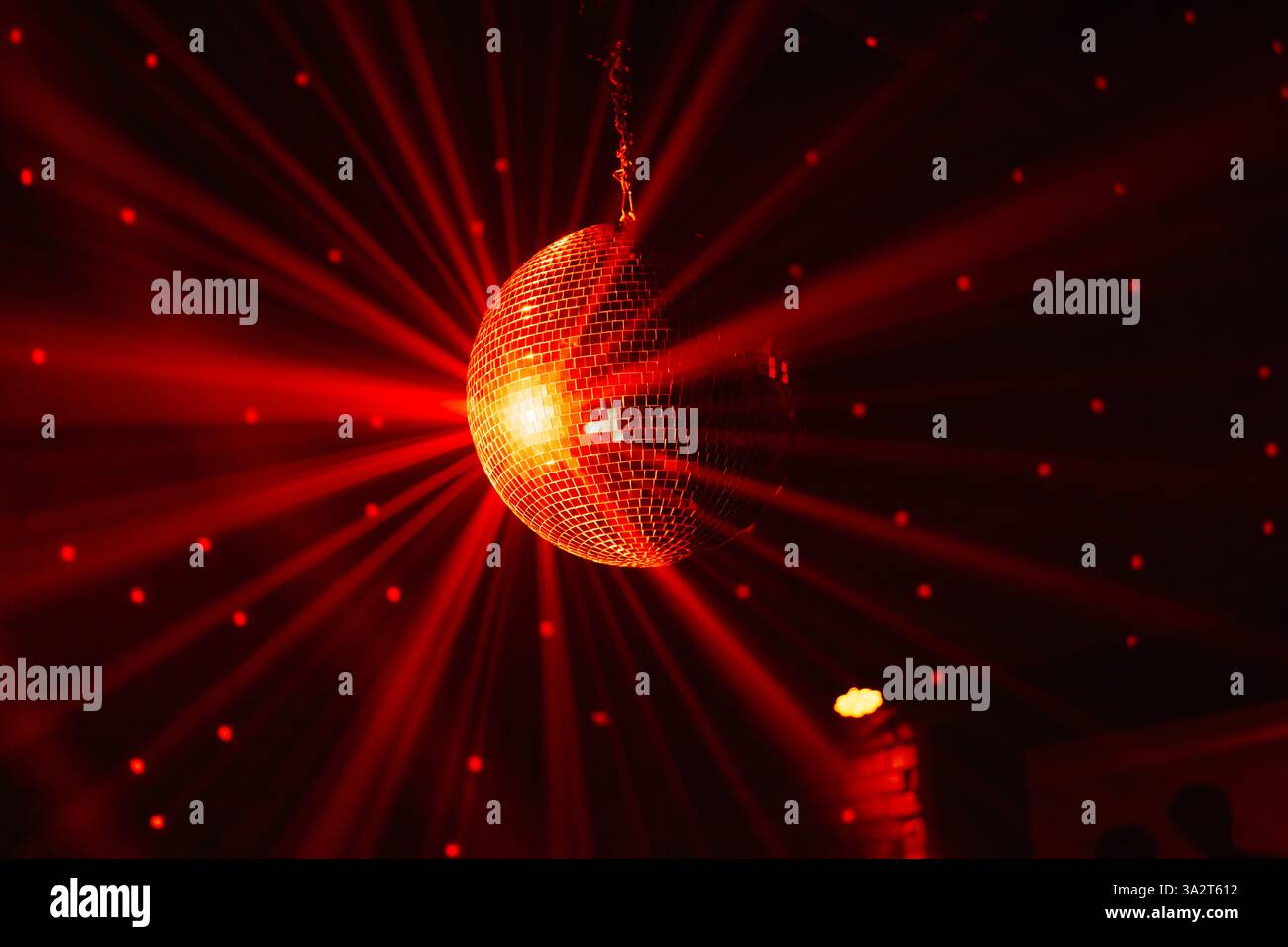 Lavish red lighting with disco ball reflecting bright patterns Stock ...