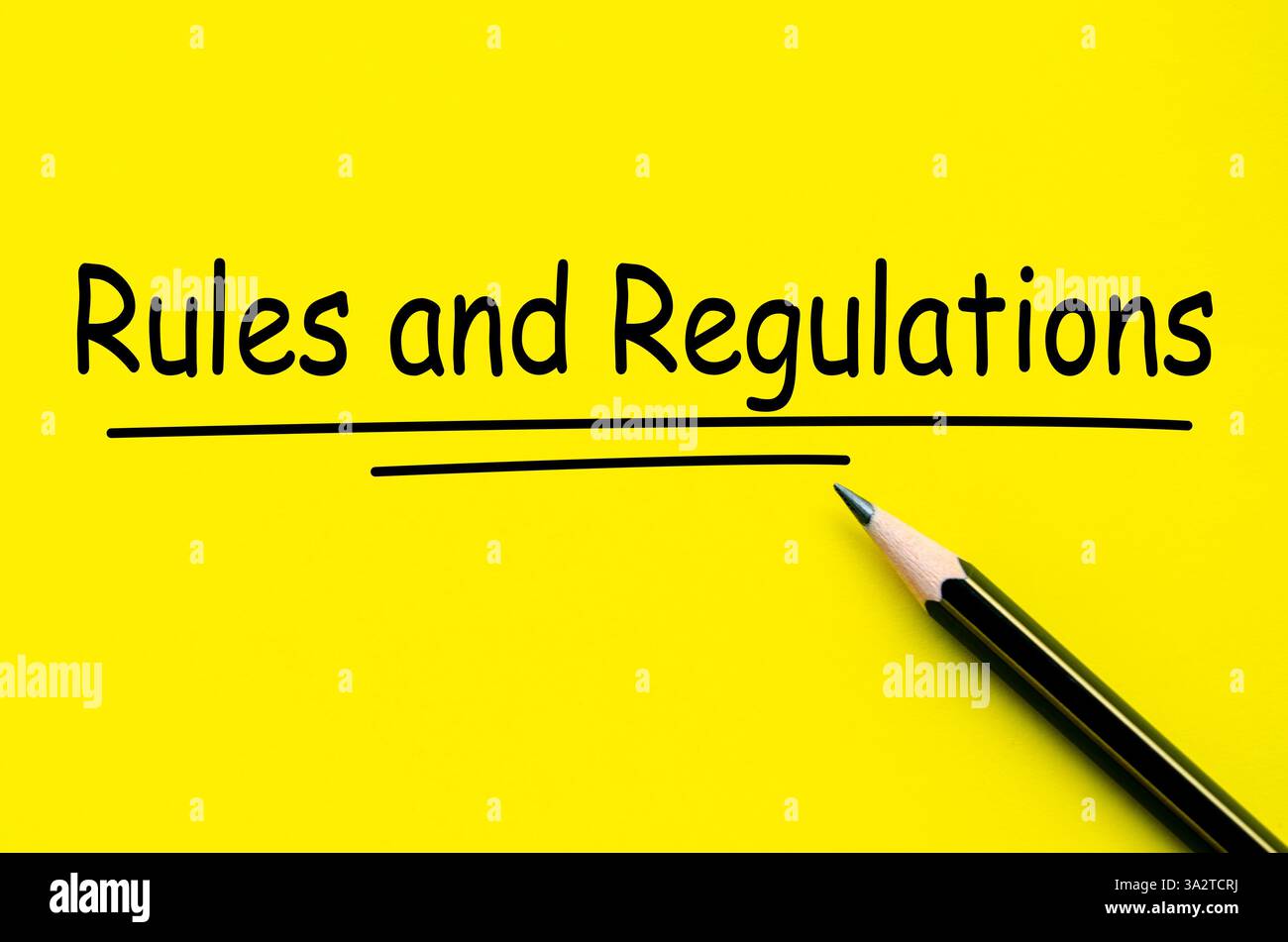 Rules and Regulation text on yellow notepad with pencil background ...