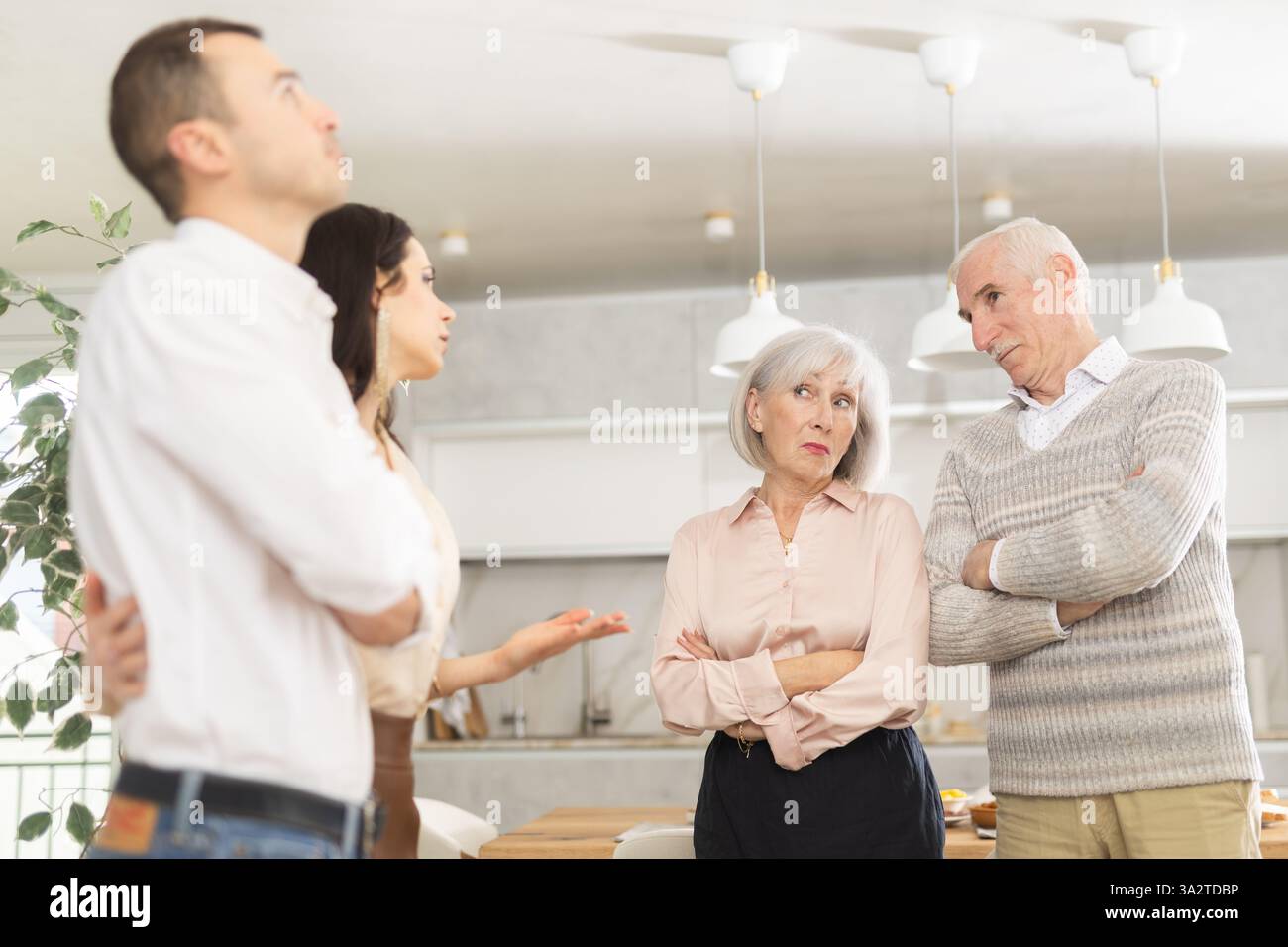 Adult daughter introducing boyfriend to disapproving elderly parents at ...