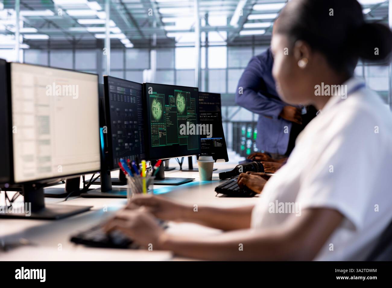 Computer scientist reconfiguring server farm to optimize it for data processing requirements of ...
