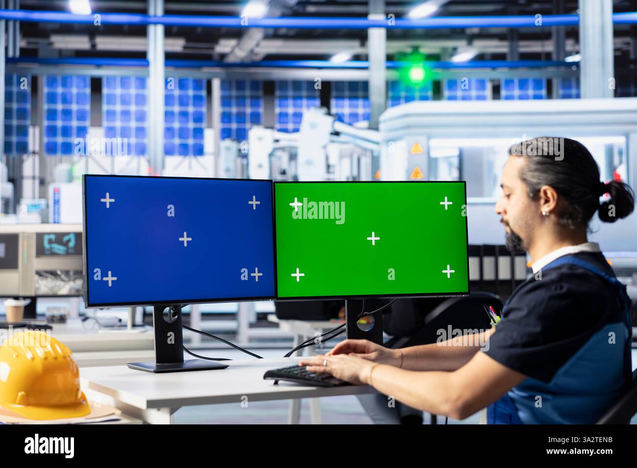 Solar panels plant engineer overseeing energy consumption on green screen PC display ...