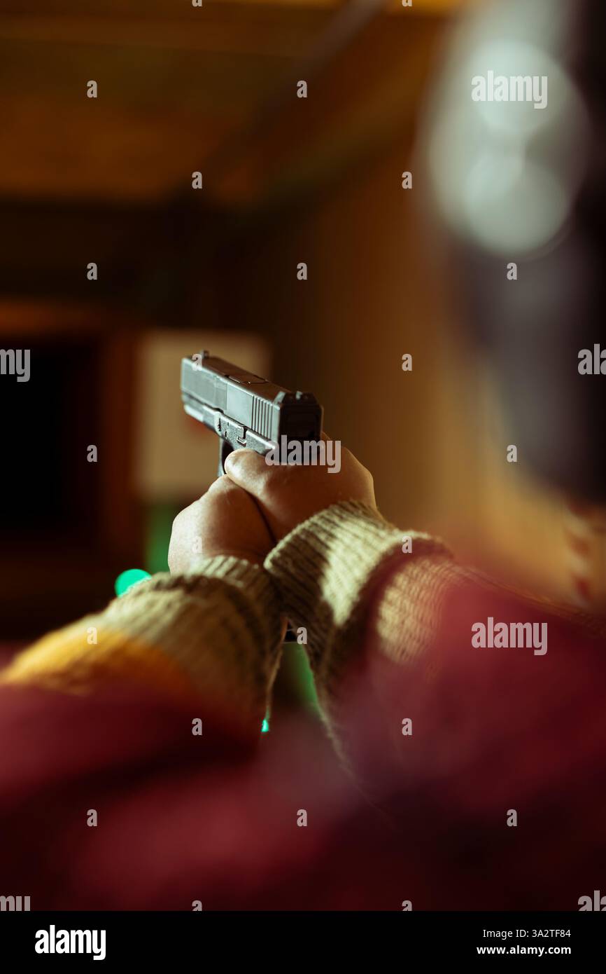 Firing range customer doing shooting activity with pistol during ...