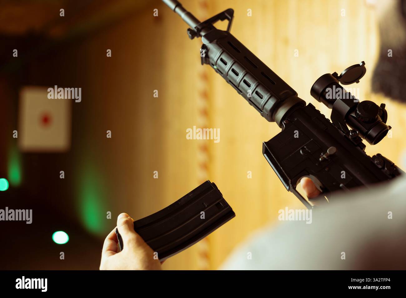 Firing range facility client reloading semiautomatic weapon following ...