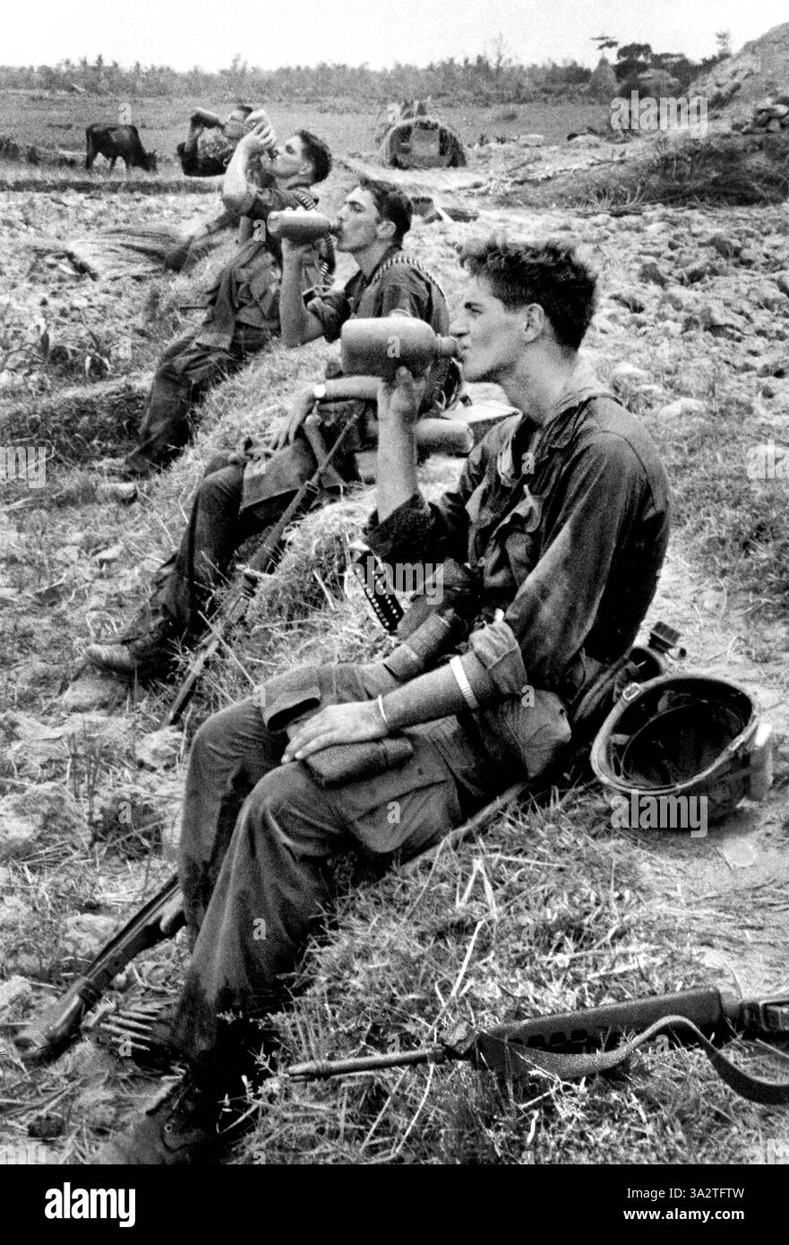 Members of U.S.25th Infantry Division drinking from their canteens ...