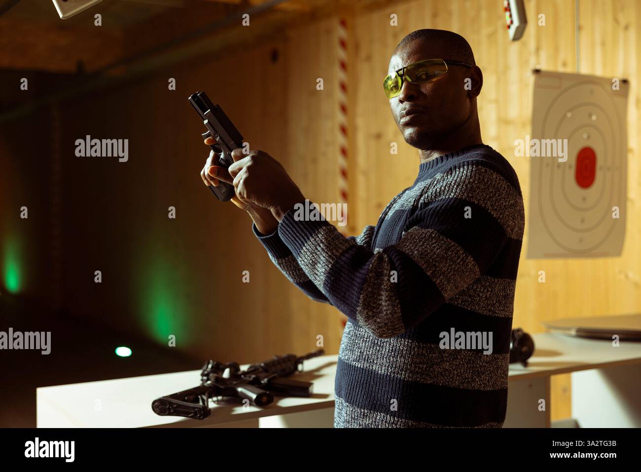 Portrait of shooting range customer wearing protection glasses ...