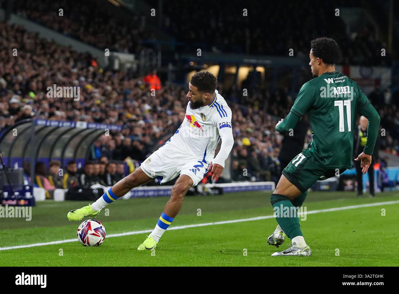 Leeds, UK. 12th Mar, 2025. Jayden Bogle of Leeds United battles with ...