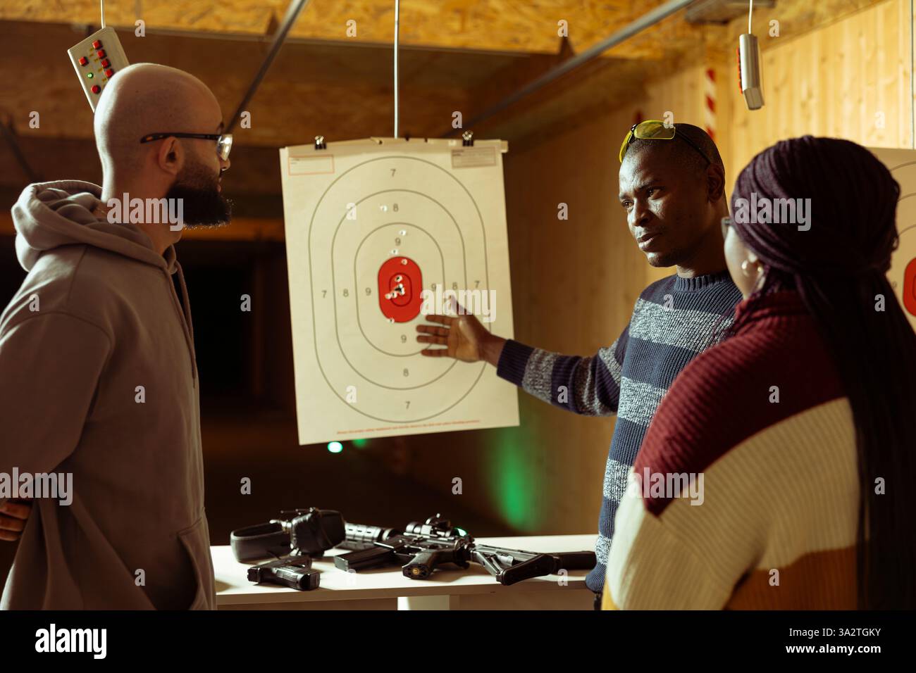 Shooting range safety officer ensuring clients are following rules and ...