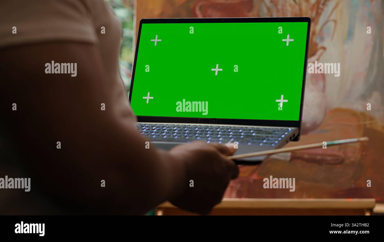 African american artist holding device with green screen mockup in ...