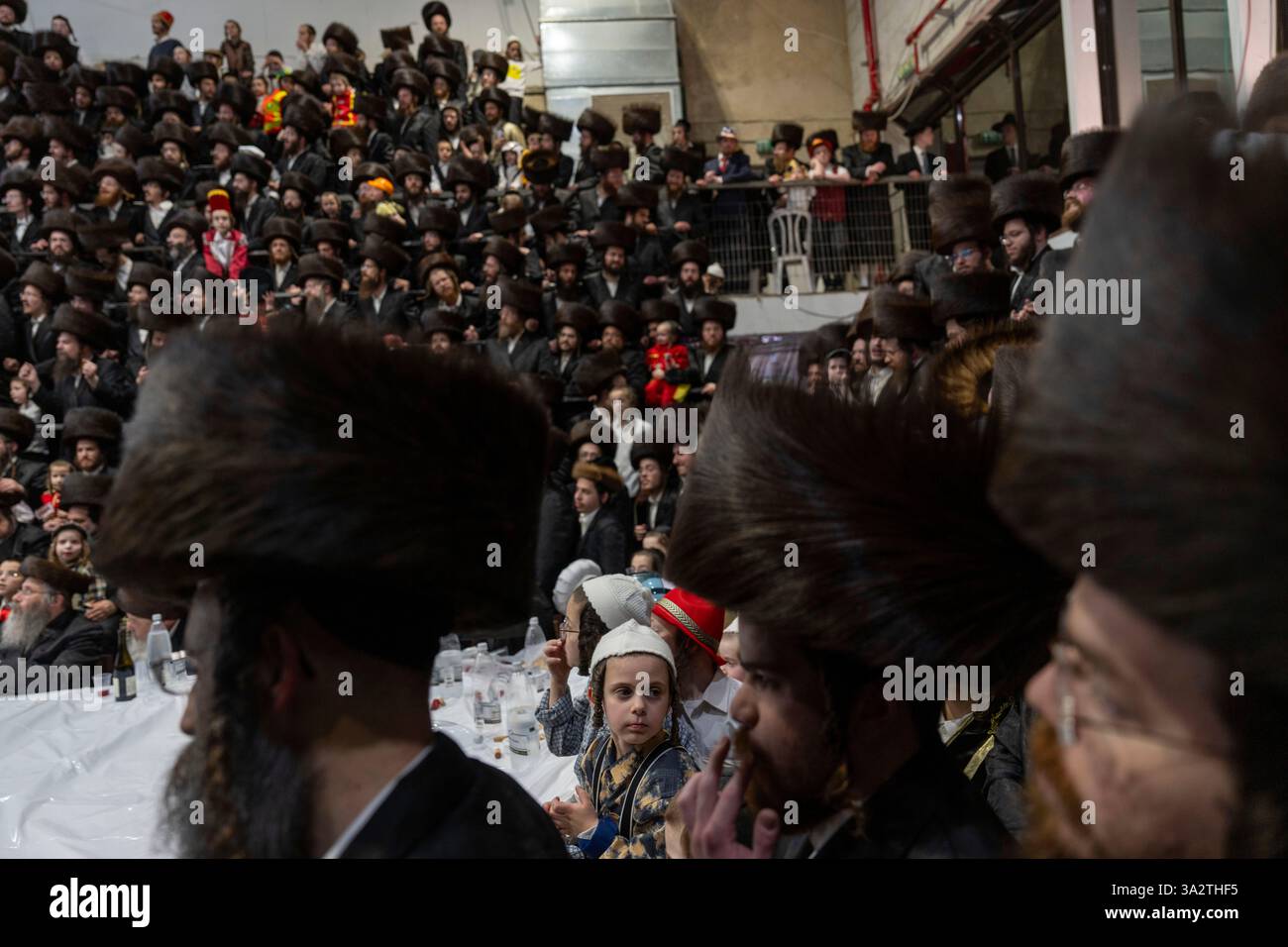 Ultra-Orthodox Jewish children and men, some wearing costumes ...
