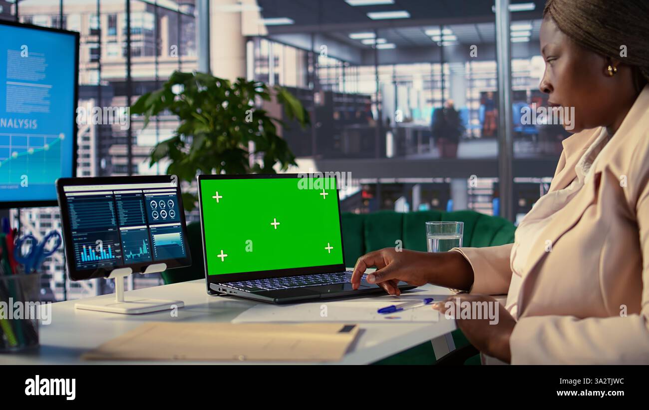 Young general manager using green screen on laptop and evaluating ...