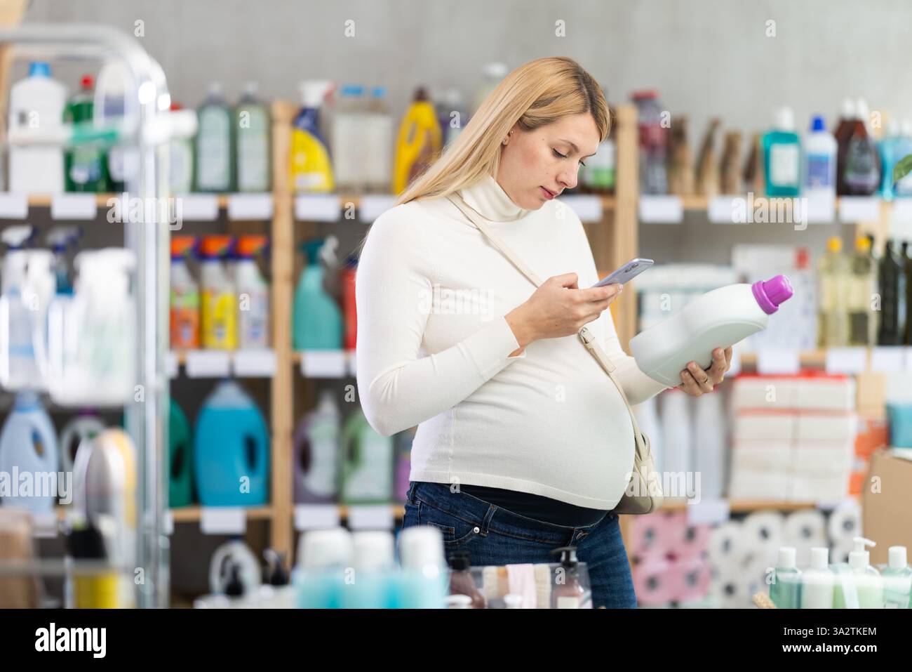 Pregnant shopper scanning fabric softener barcode for mobile payment ...