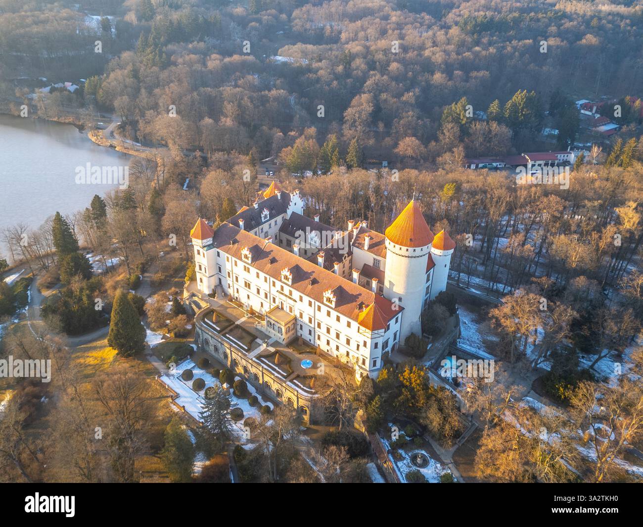 This aerial view showcases Konopiste Castle surrounded by lush forests ...