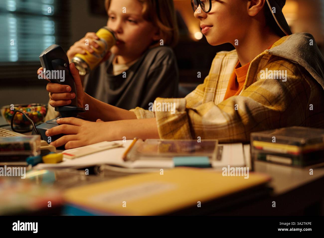 Two children engrossed in playing a vintage video game console ...