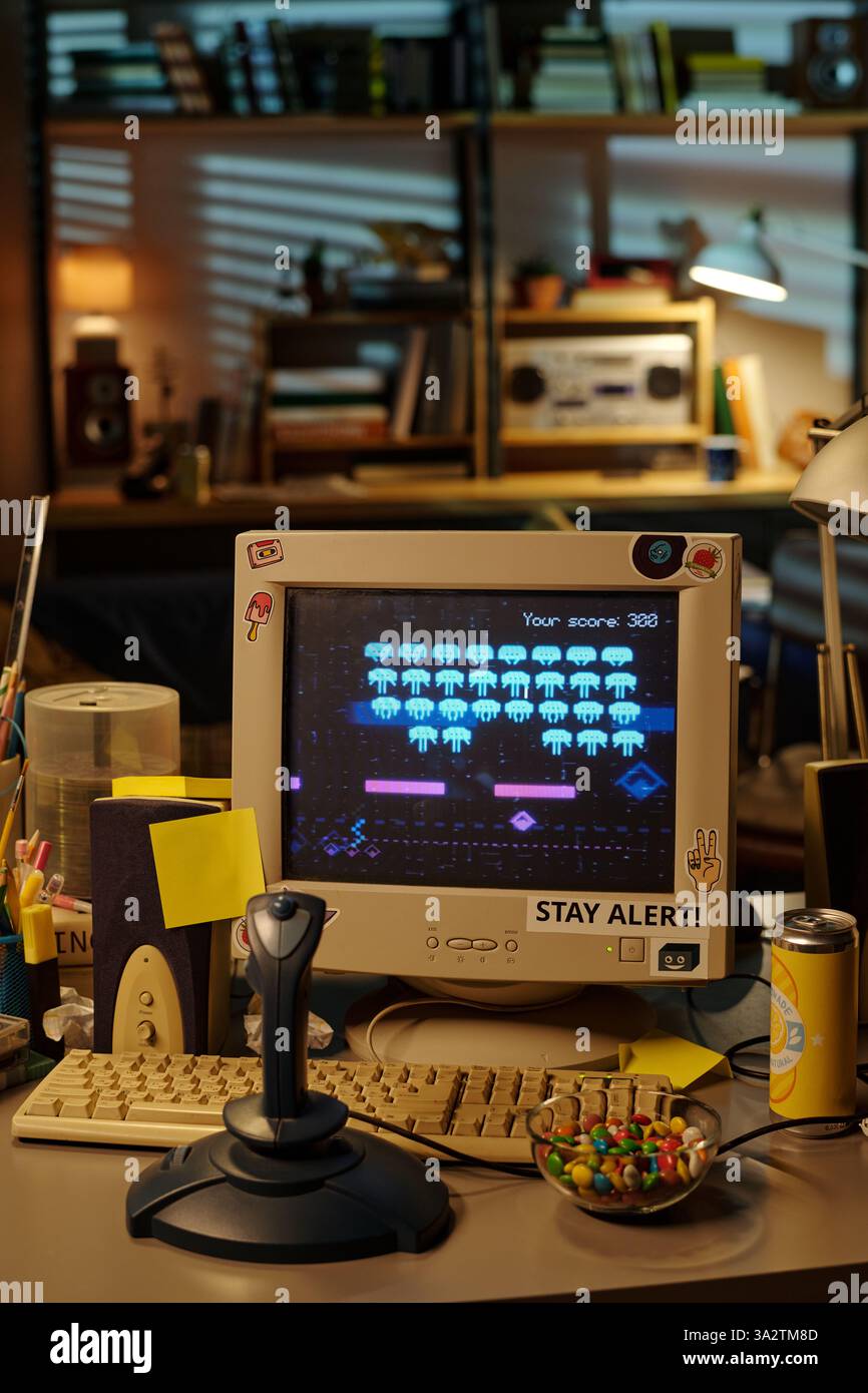 Retro-themed desk scene with vintage computer showing classic arcade ...