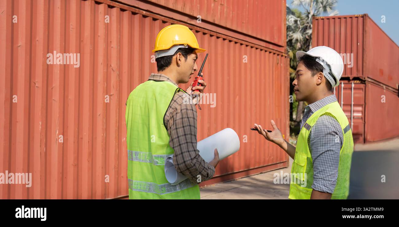 Logistics teamwork. Engineers discussing plans at a shipping container ...