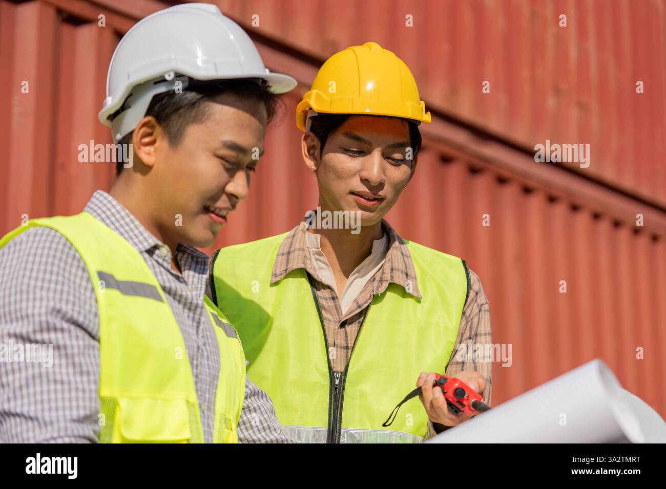 Engineering Collaboration. Two young engineers discussing logistics ...