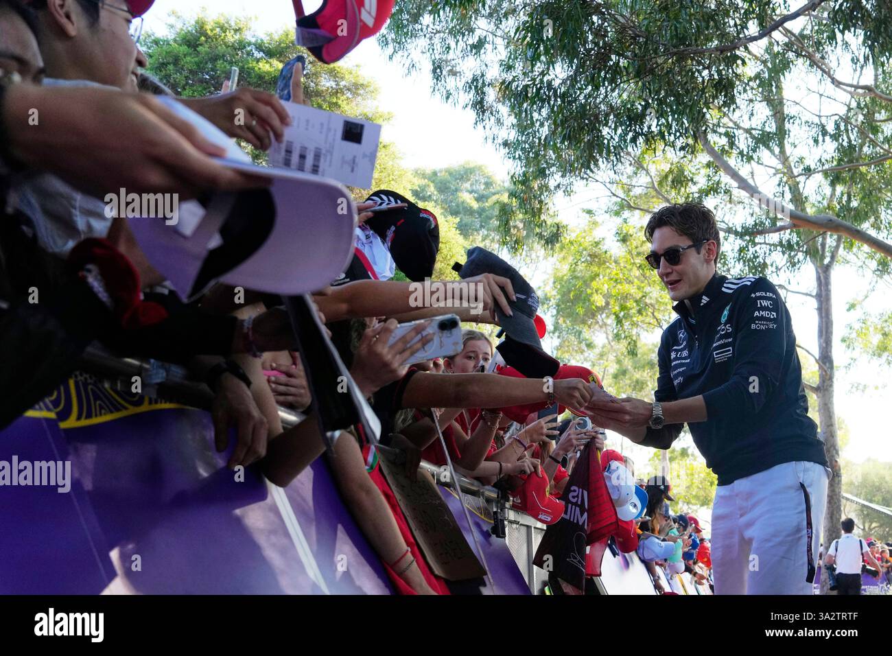 Mercedes driver George Russell of Britain signs autographs as he ...