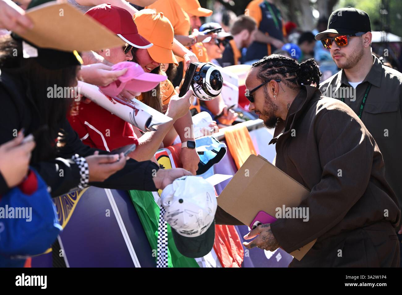 Lewis Hamilton of Ferrari greets fan on arrival at the Albert Park ...