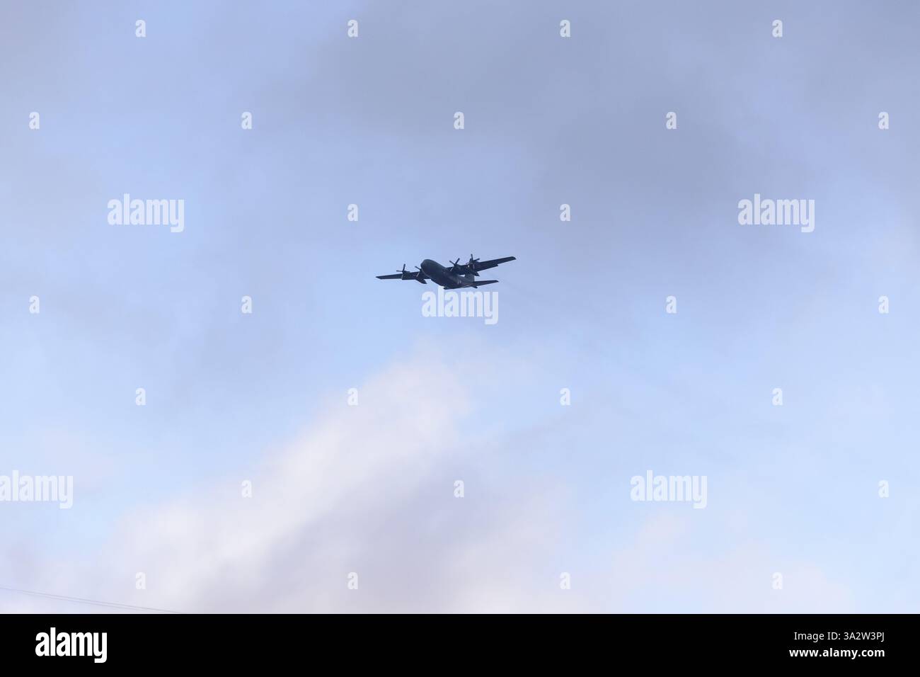 Azores, Portugal, 09.07.2024: Airplane in the cloudy sky. CC-130H ...