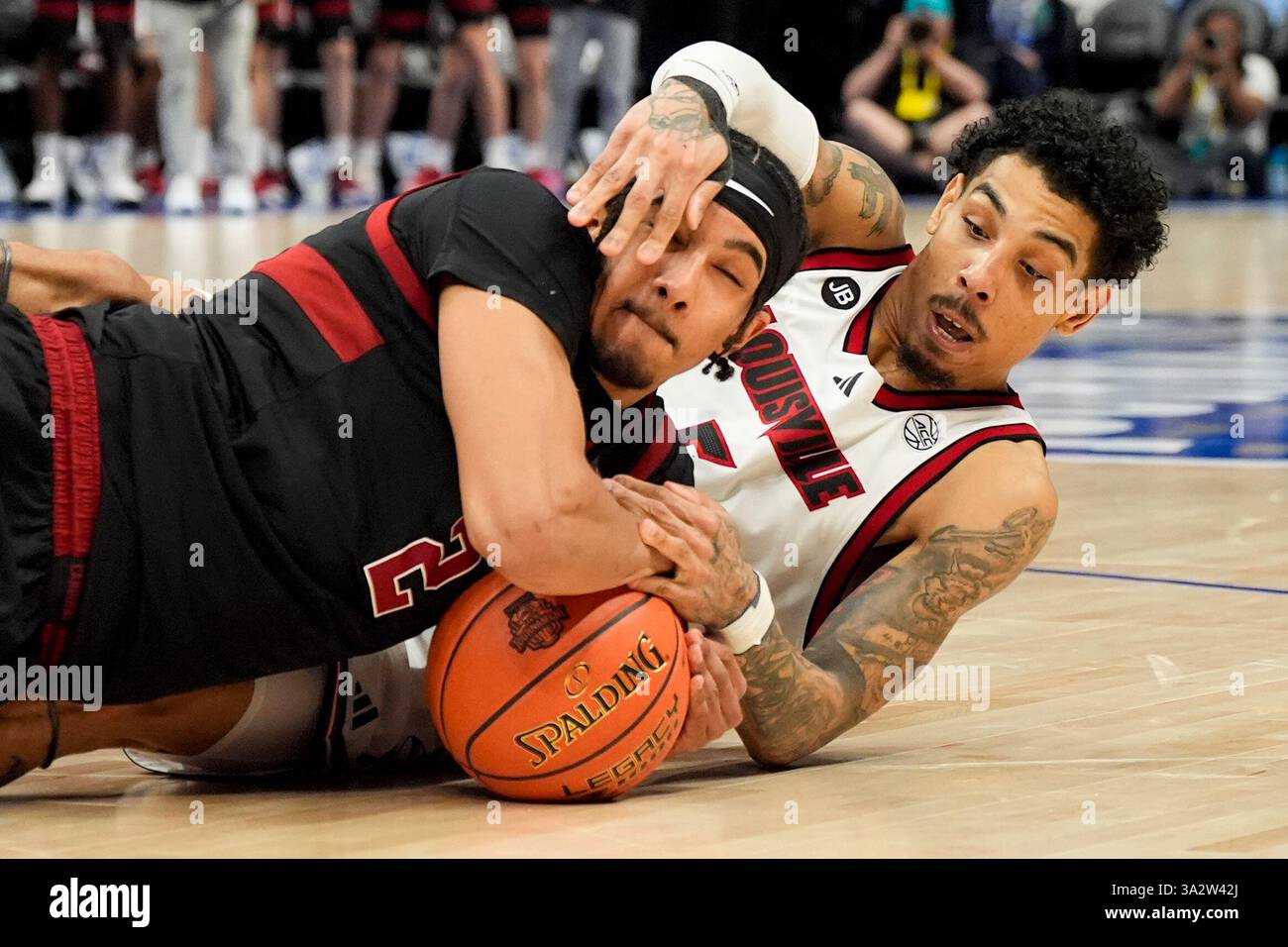 Louisville guard Terrence Edwards Jr. vies for the ball with Stanford ...