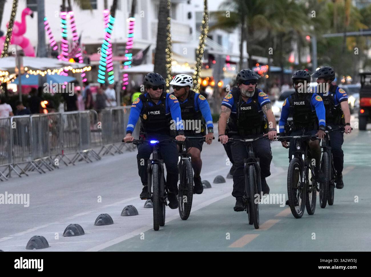 City of Miami police officers patrol on bicycles along Ocean Drive ...