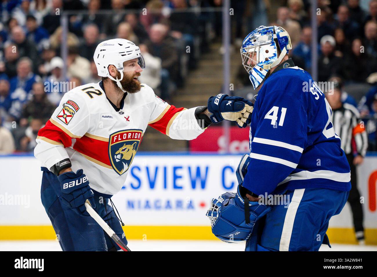 Florida Panthers' Jonah Gadjovich (12) pokes Toronto Maple Leafs ...