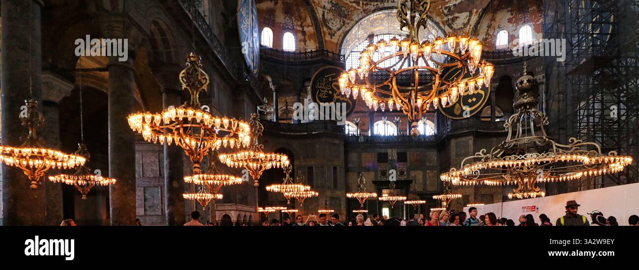 Tourists admire the grand Chandeliers inside the Hagia Sophia ...