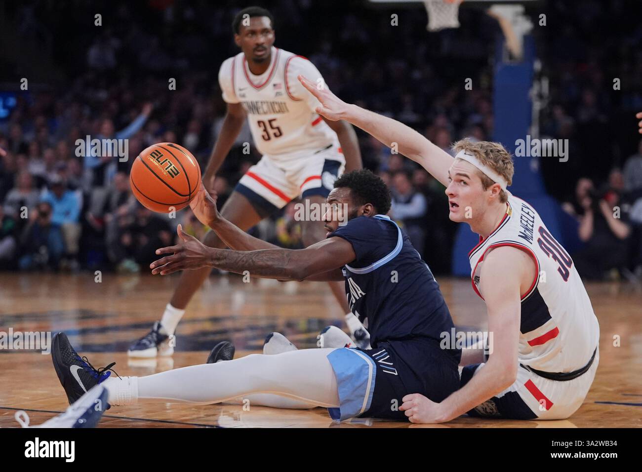 UConn's Liam McNeeley (30) looks to pass during the first half of an ...