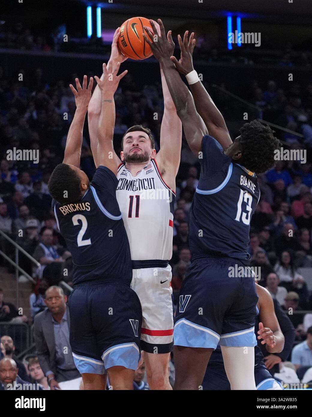 Villanova's Jhamir Brickus (2) and Enoch Boakye (13) defend a shot by ...