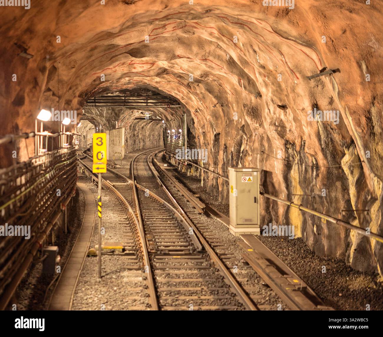 Lit underground tunnel in Rådhuset metro station, Stockholm Stock Photo ...