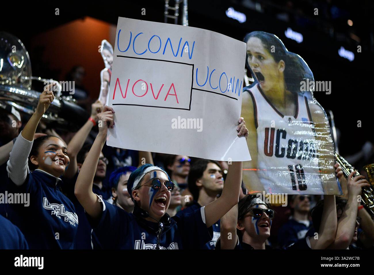 March 9, 2025: The UConn Pep Band celebrates with a sign with a bracket ...