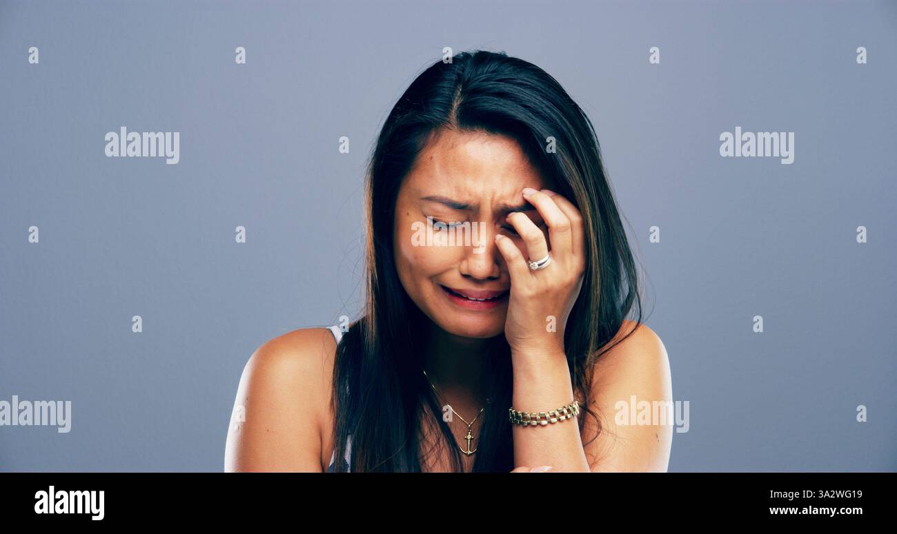 Heartbreak, crying and woman with tears, studio or sad for loss of toxic relationship, grief or ...