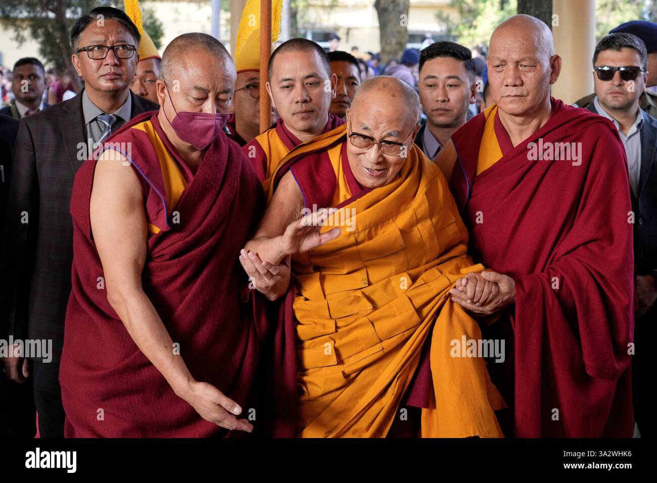 Tibetan spiritual leader the Dalai Lama, in yellow robe, arrives to ...