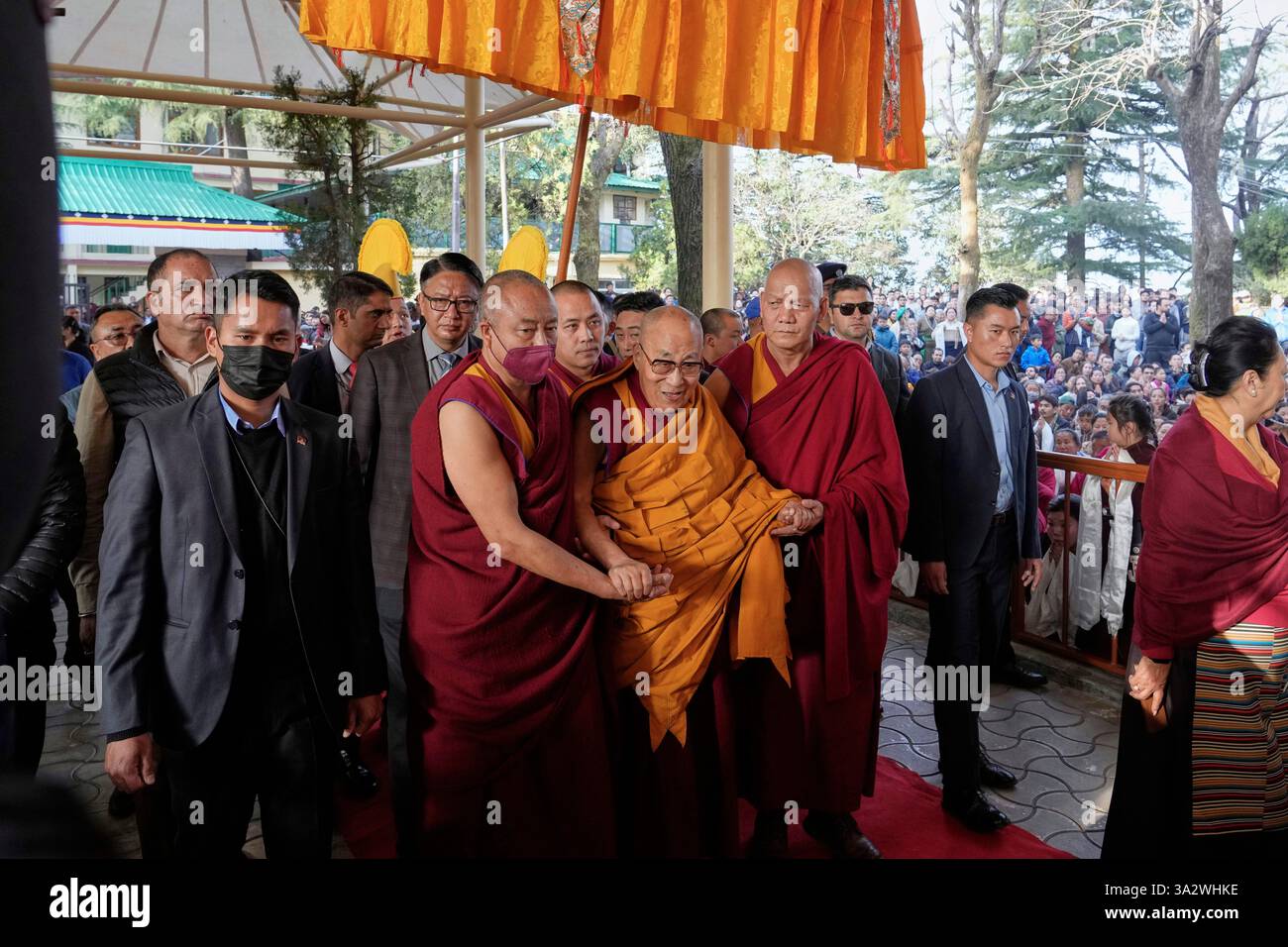 Tibetan spiritual leader the Dalai Lama, in yellow robe, arrives to ...