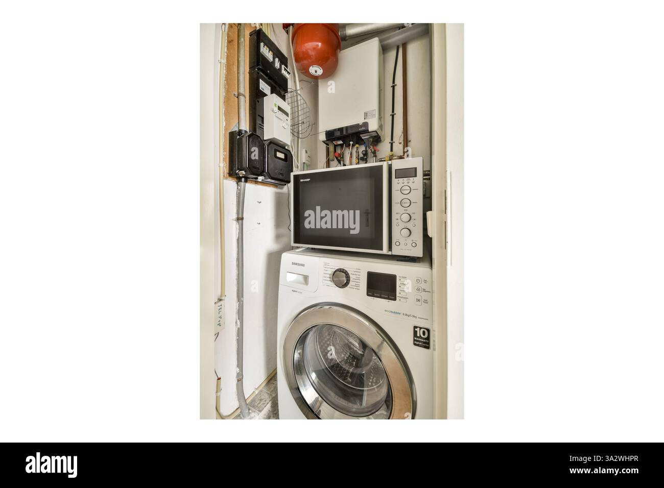 A neatly organized laundry space featuring a modern washing machine and ...