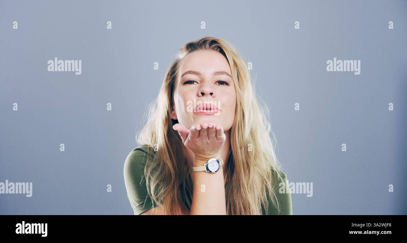 Flirting, woman and blowing kiss in studio, portrait and gesture for ...