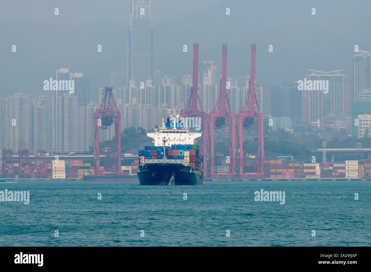 Hong Kong. China- 02.18.2025. A container cargo ship loaded with shipping containers sailing ...