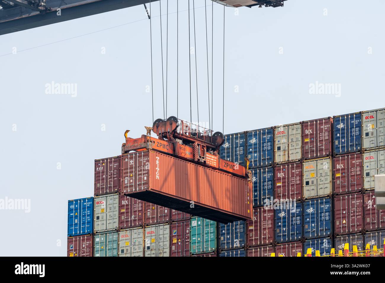 Hong Kong. China- 02.18.2025. A shipping container being lifted in mid ...