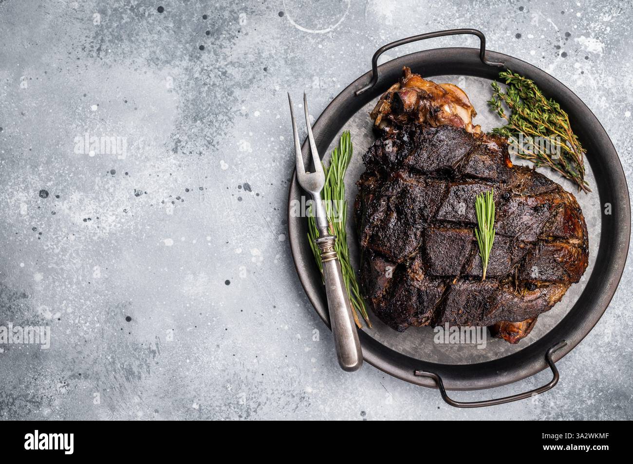 Slow cooked venison roast leg. Braised game meat of deer with bone ...