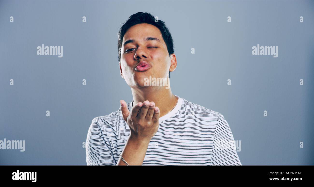 Portrait, man and blowing kiss with wink for romance, affection or love ...