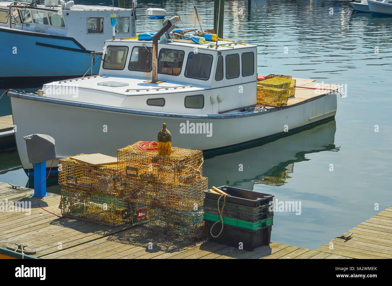 Fishing boats and lobster traps at the dock in the harbor of Gloucester ...