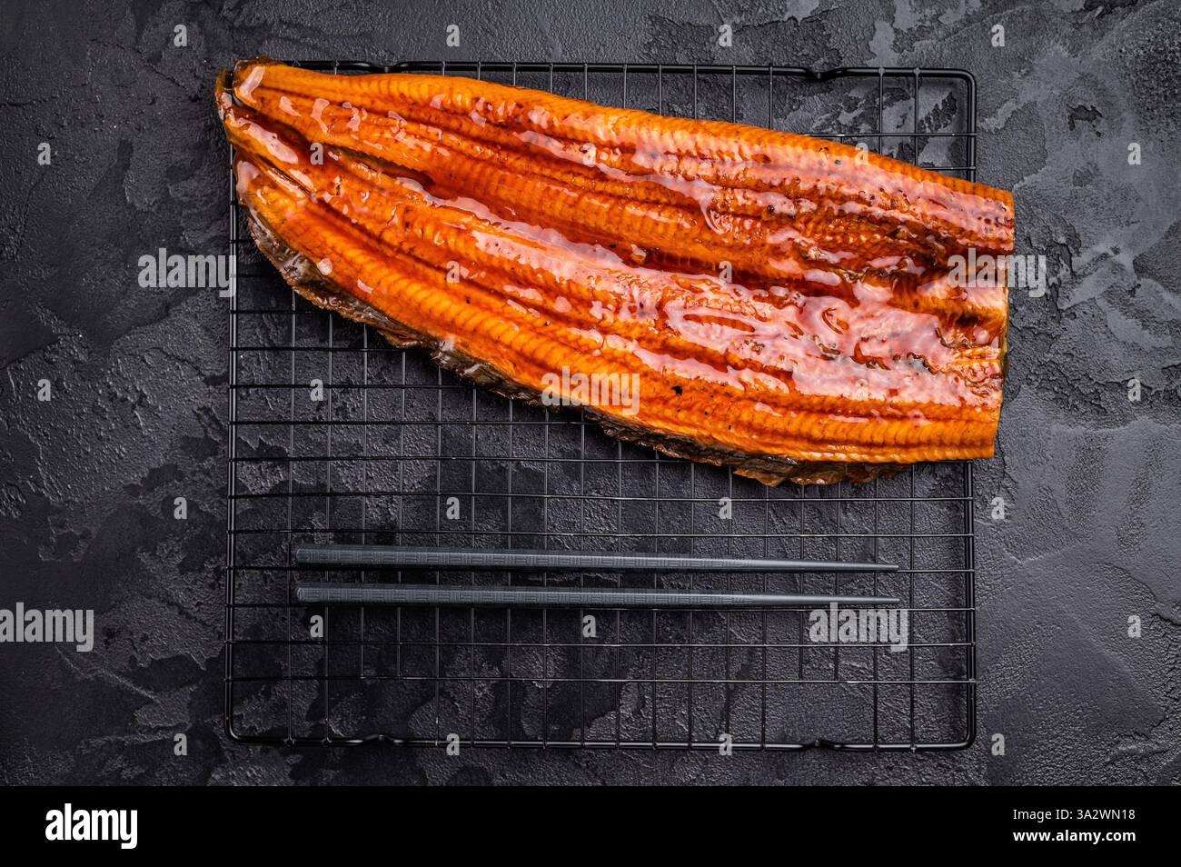Japanese unagi eel, grilled fish fillet of eel. black background. top view Stock Photo - Alamy