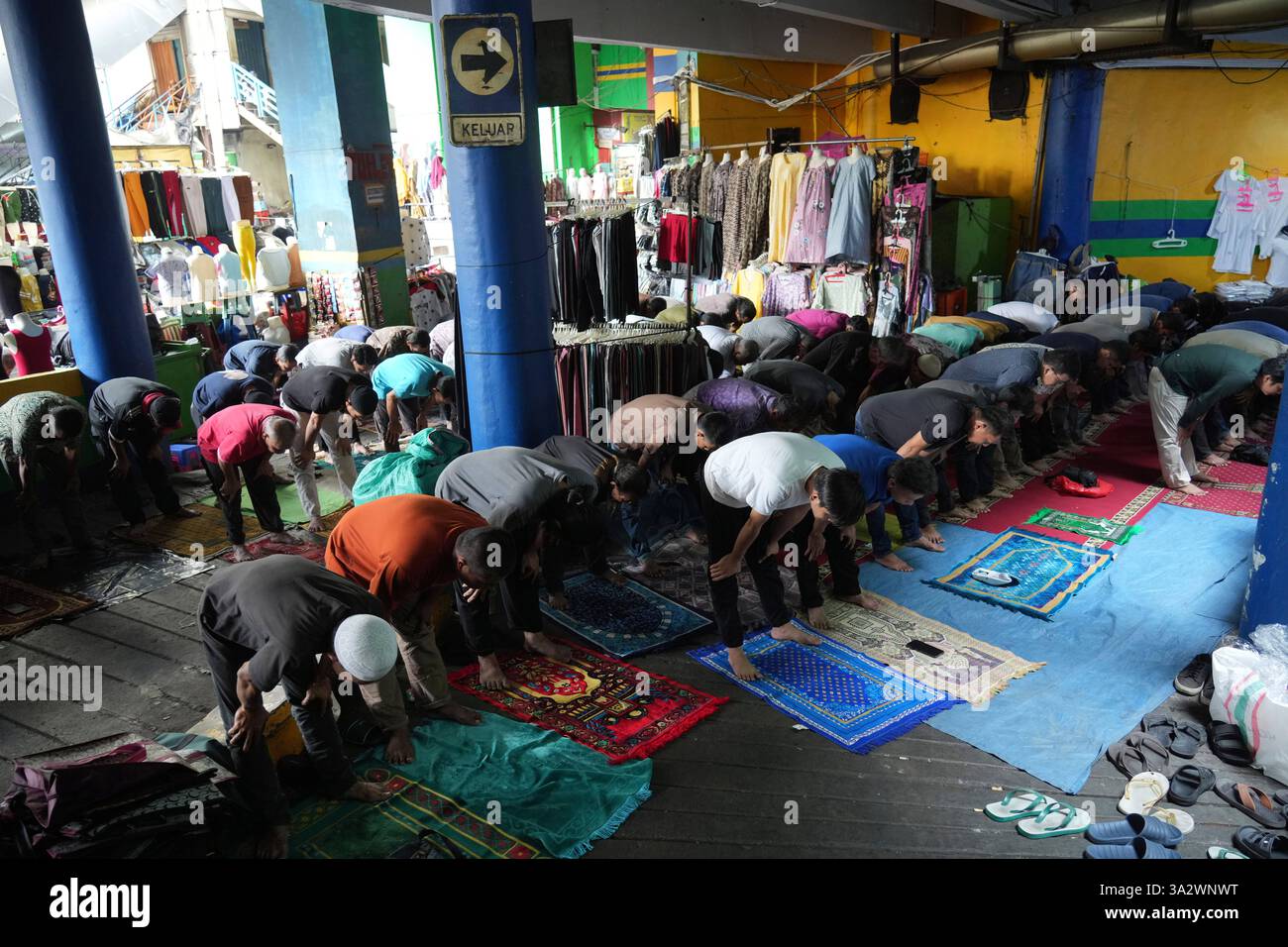 Muslim men perform Friday prayer during Ramadan, at Tanah Abang market ...